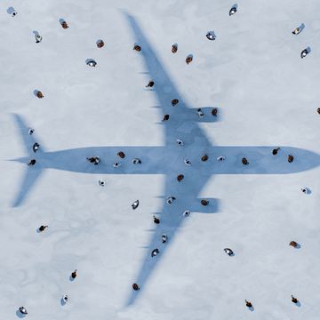 silhouette shadow of airplane over crowd of people
